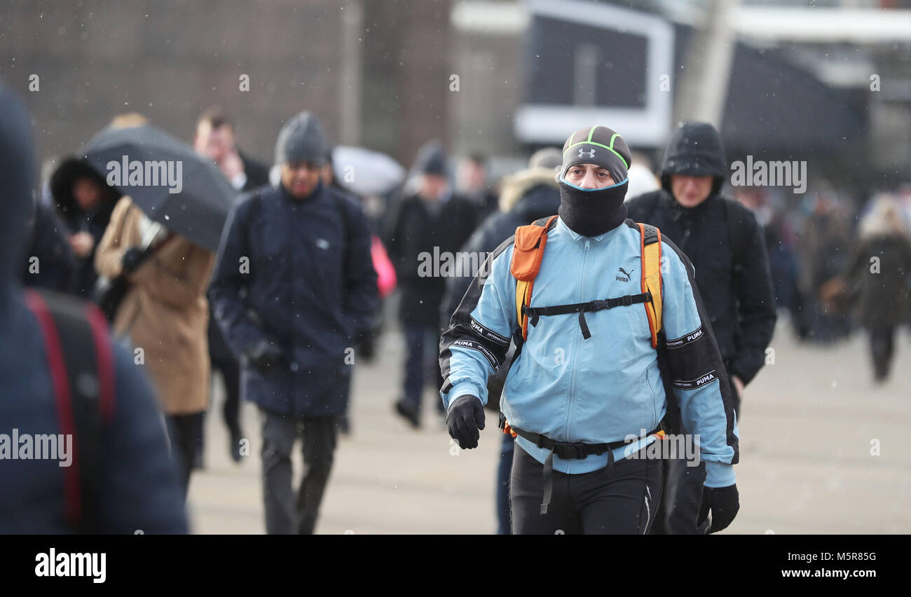 Commuters walking in the snow near London Bridge, as some parts of the ...