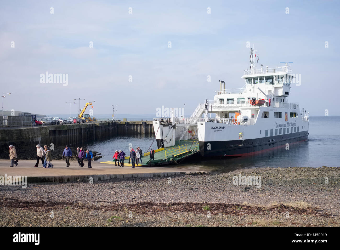 Ferry arrival at port dock with people passengers walking off board to ...