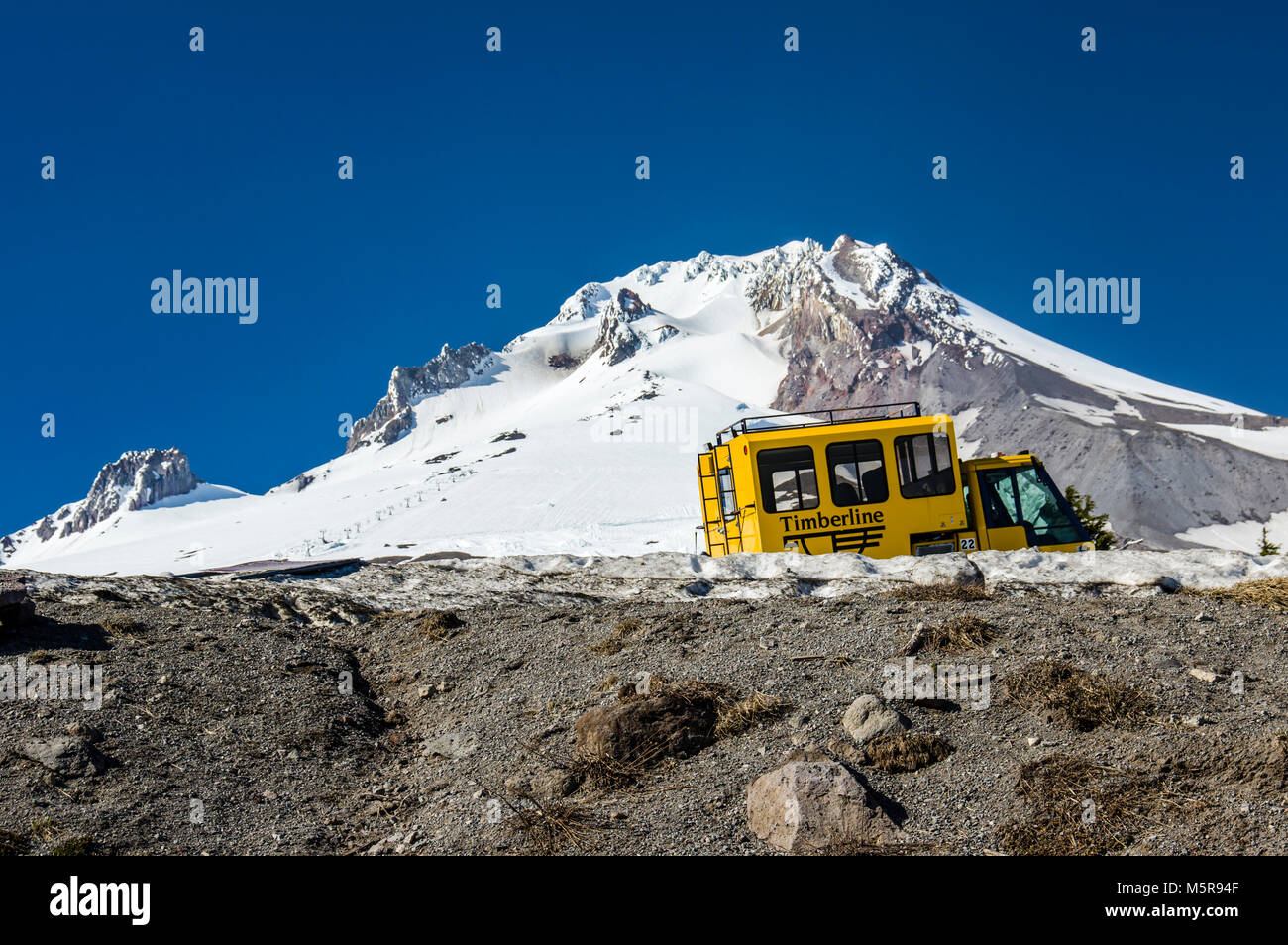 A yellow Sno-Cat with Palmer Snow Field in the background just outside ...