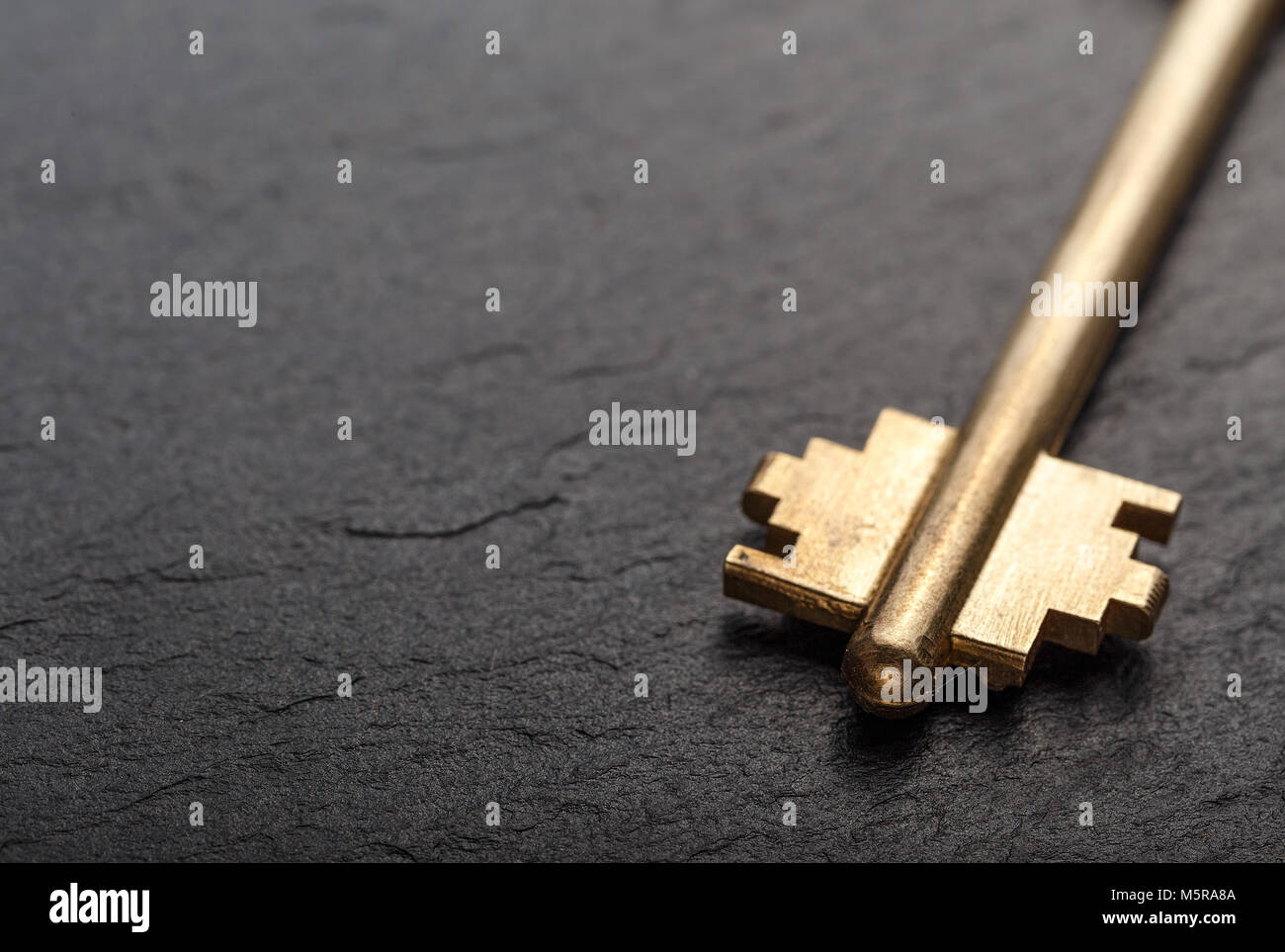 Golden metal key on a black background, horizontal photo Stock Photo ...