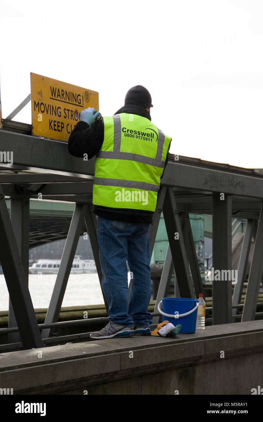 Colour Photograph of a man cleaning a bridge. London, England, UK ...