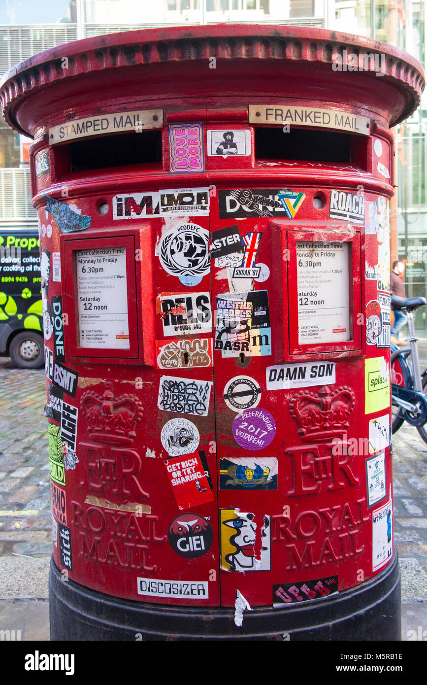 A Soho post box covered in stickers Stock Photo - Alamy
