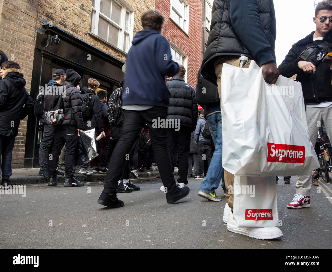 People queue for skateboarding clothes at the Supreme store in Soho ...