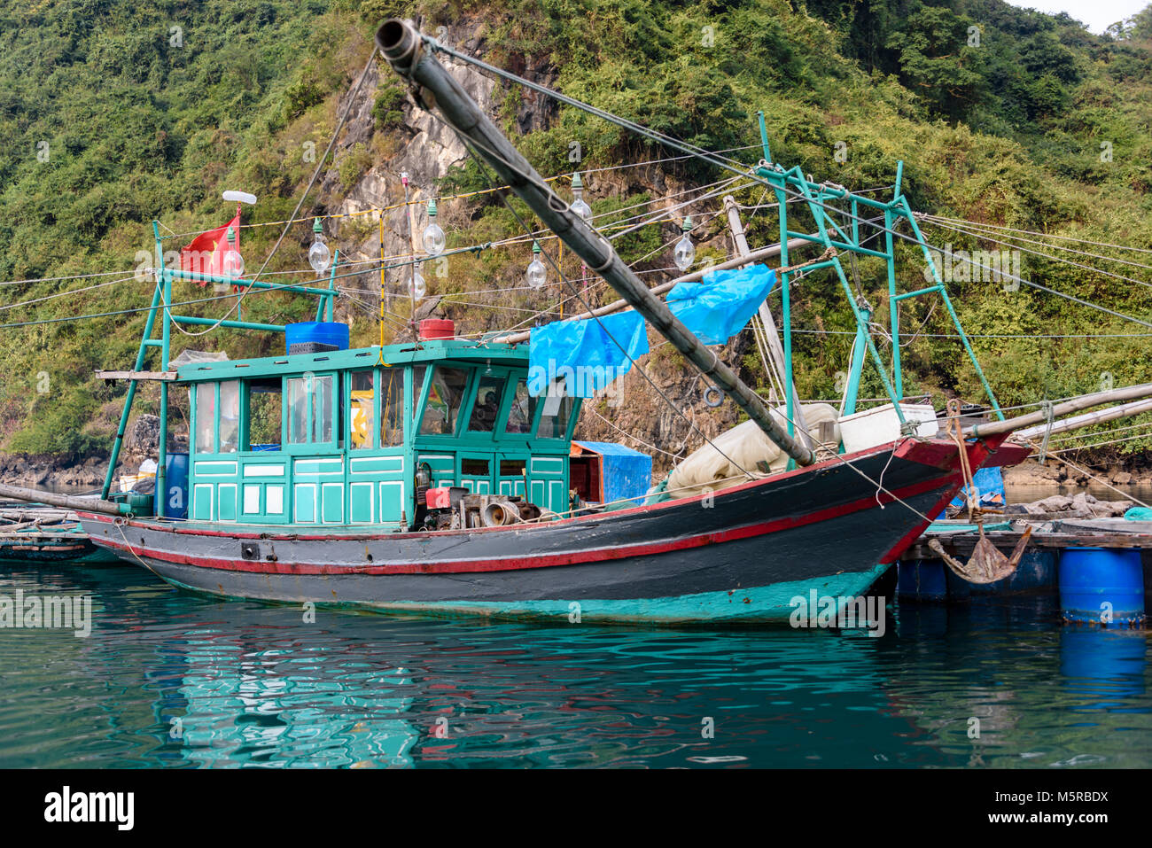 A squid boat, lined with powerful bulbs at the Cua Van floating village ...