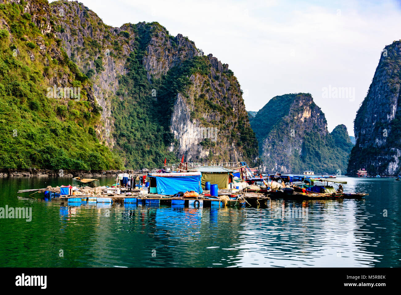 Makeshift homes on floating platforms at the Cua Van floating village ...