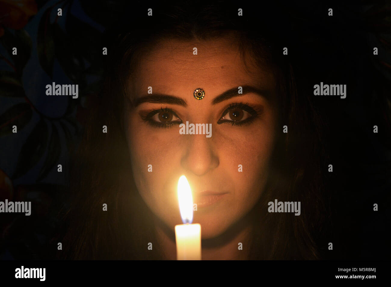 Woman's face with candle in the dark Stock Photo - Alamy