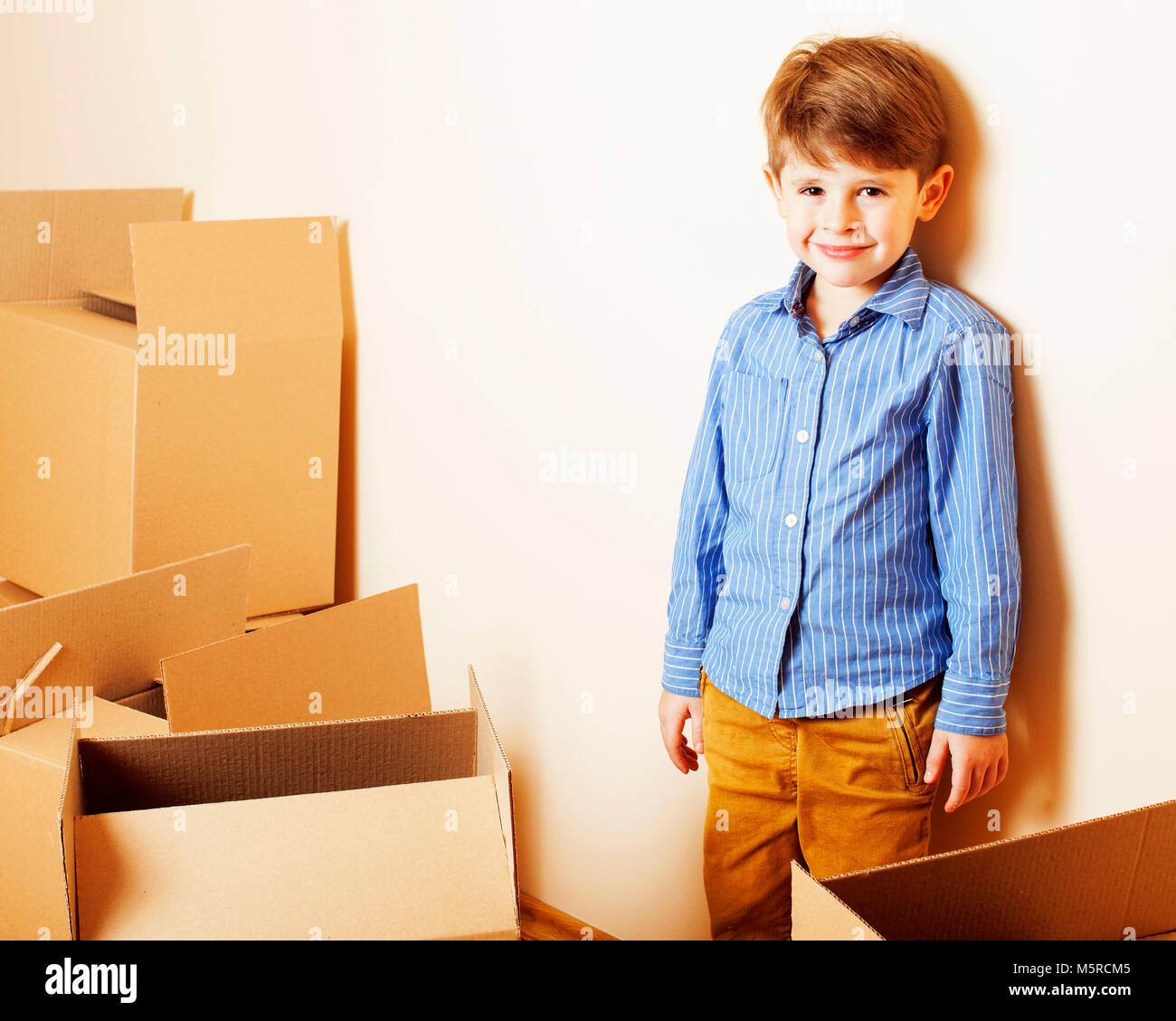 little cute boy in empty room, remoove to new house. home alone Stock ...