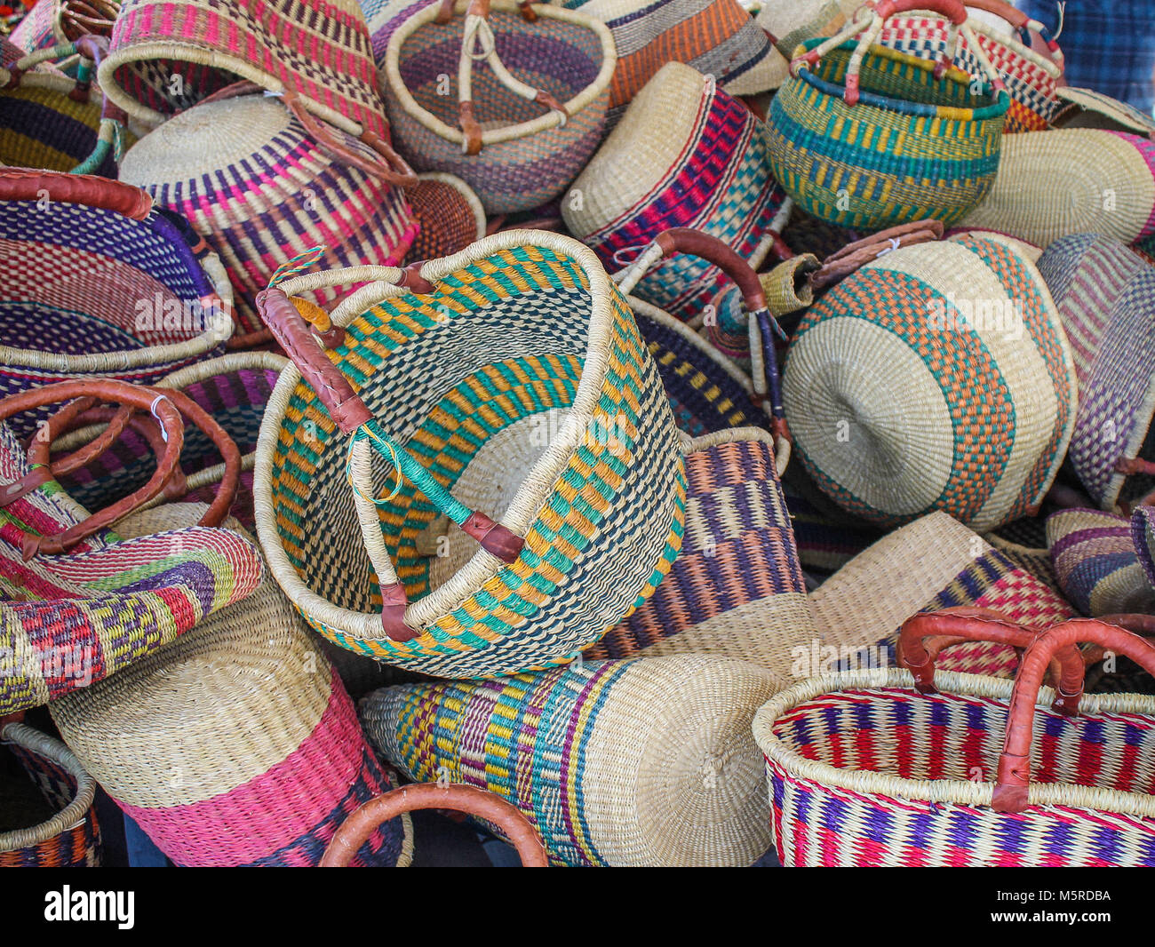 Multi colored baskets at farmers market Stock Photo - Alamy