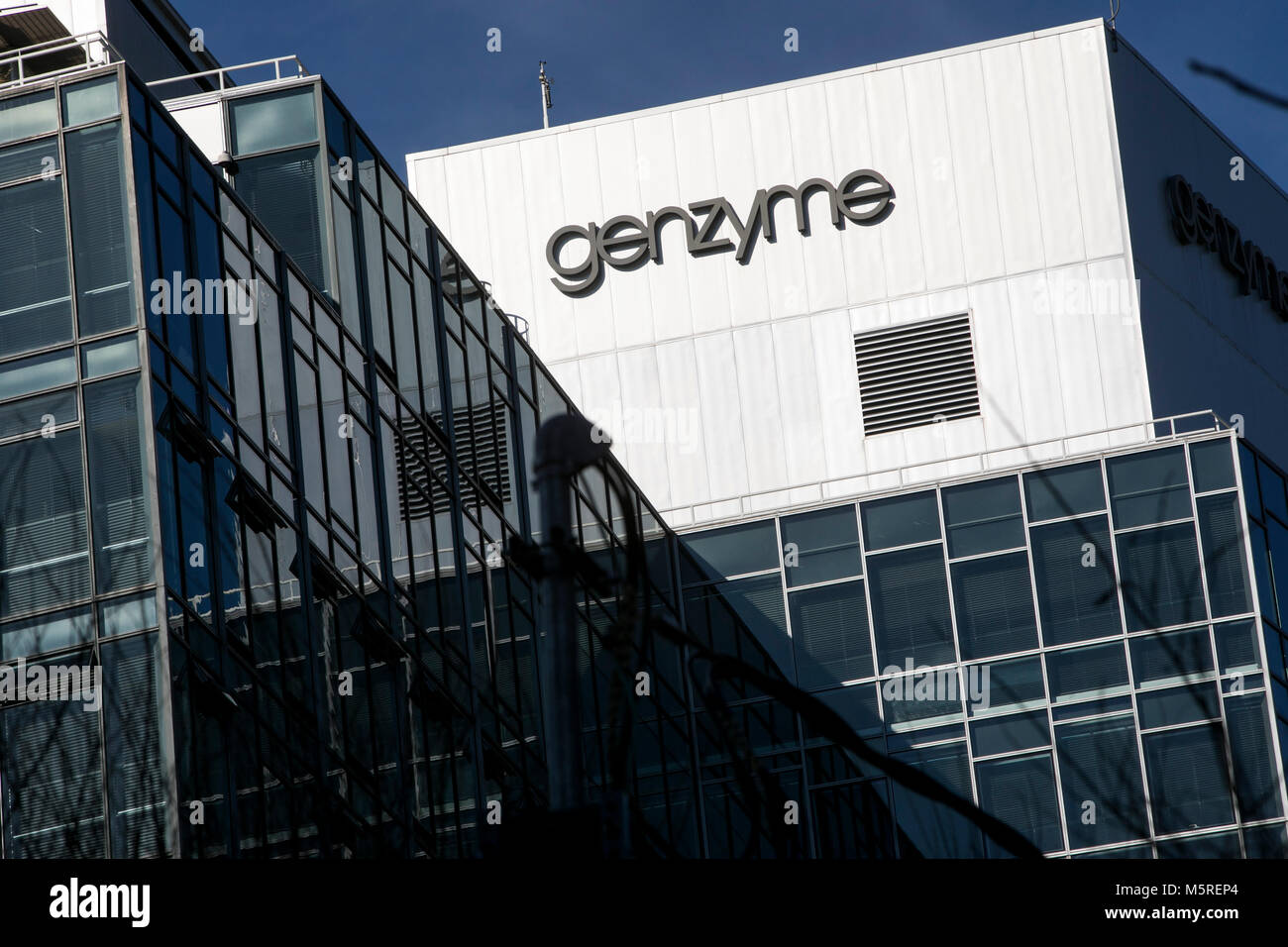A logo sign outside of the headquarters of Sanofi Genzyme in Cambridge ...
