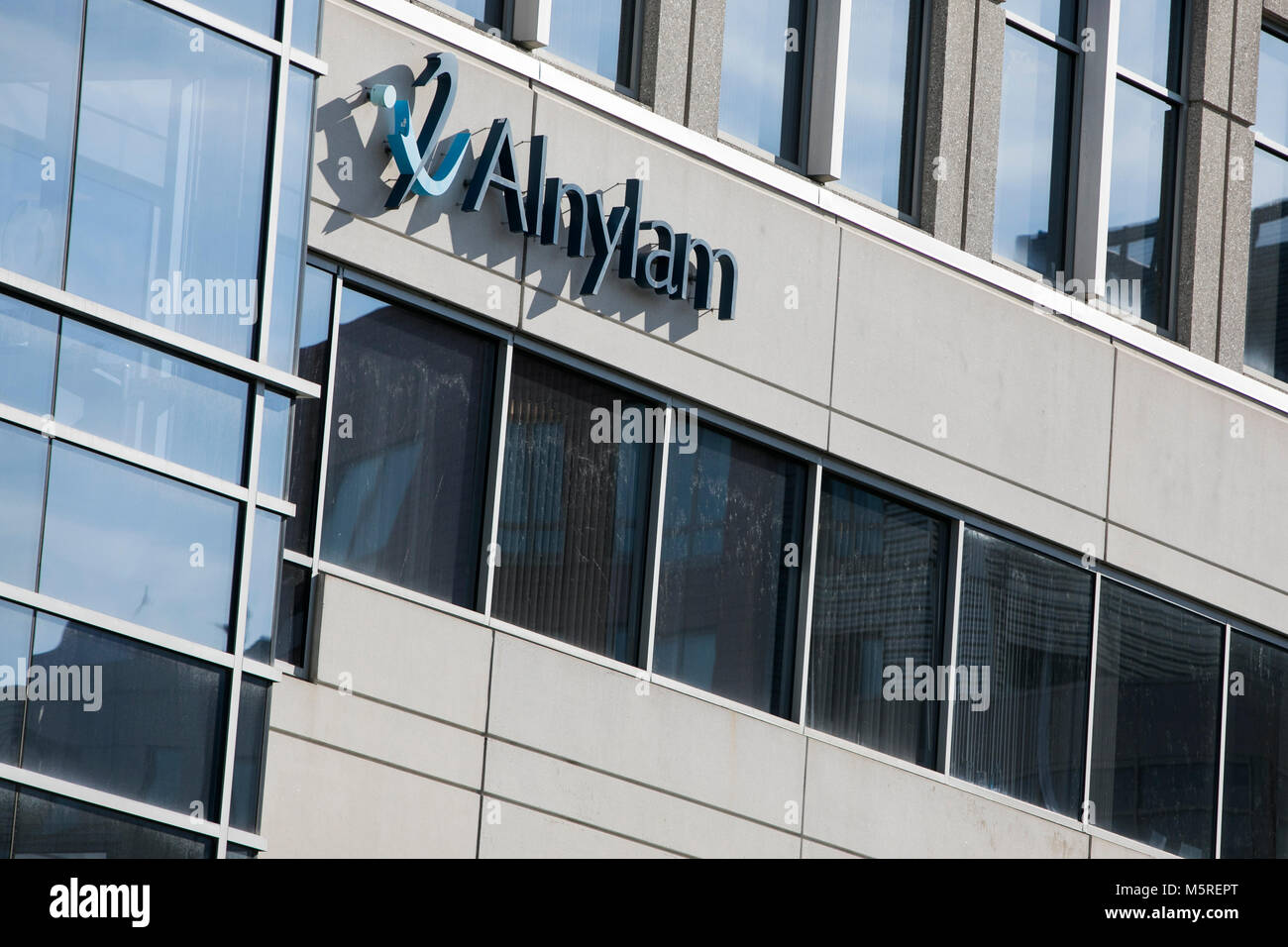 A logo sign outside of the headquarters of Alnylam Pharmaceuticals in ...