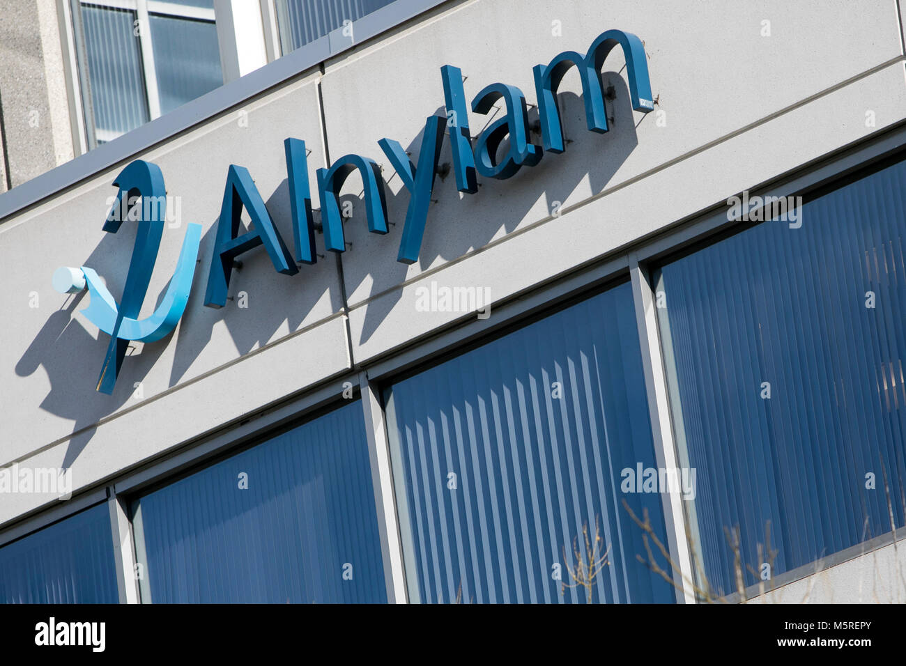 A logo sign outside of the headquarters of Alnylam Pharmaceuticals in ...