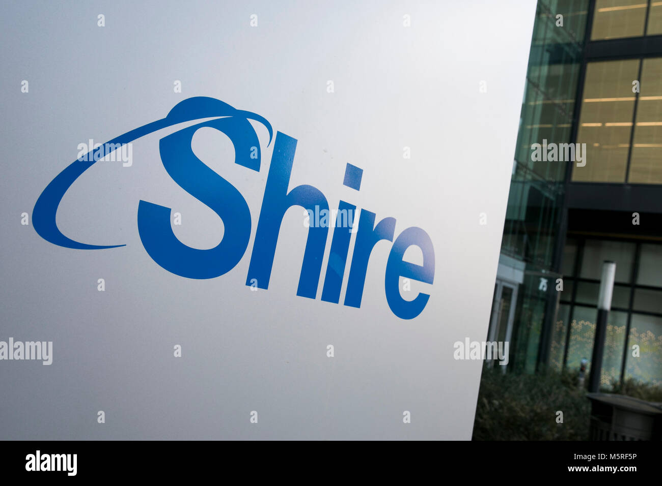 A logo sign outside of a facility occupied by Shire, Plc., in Cambridge ...