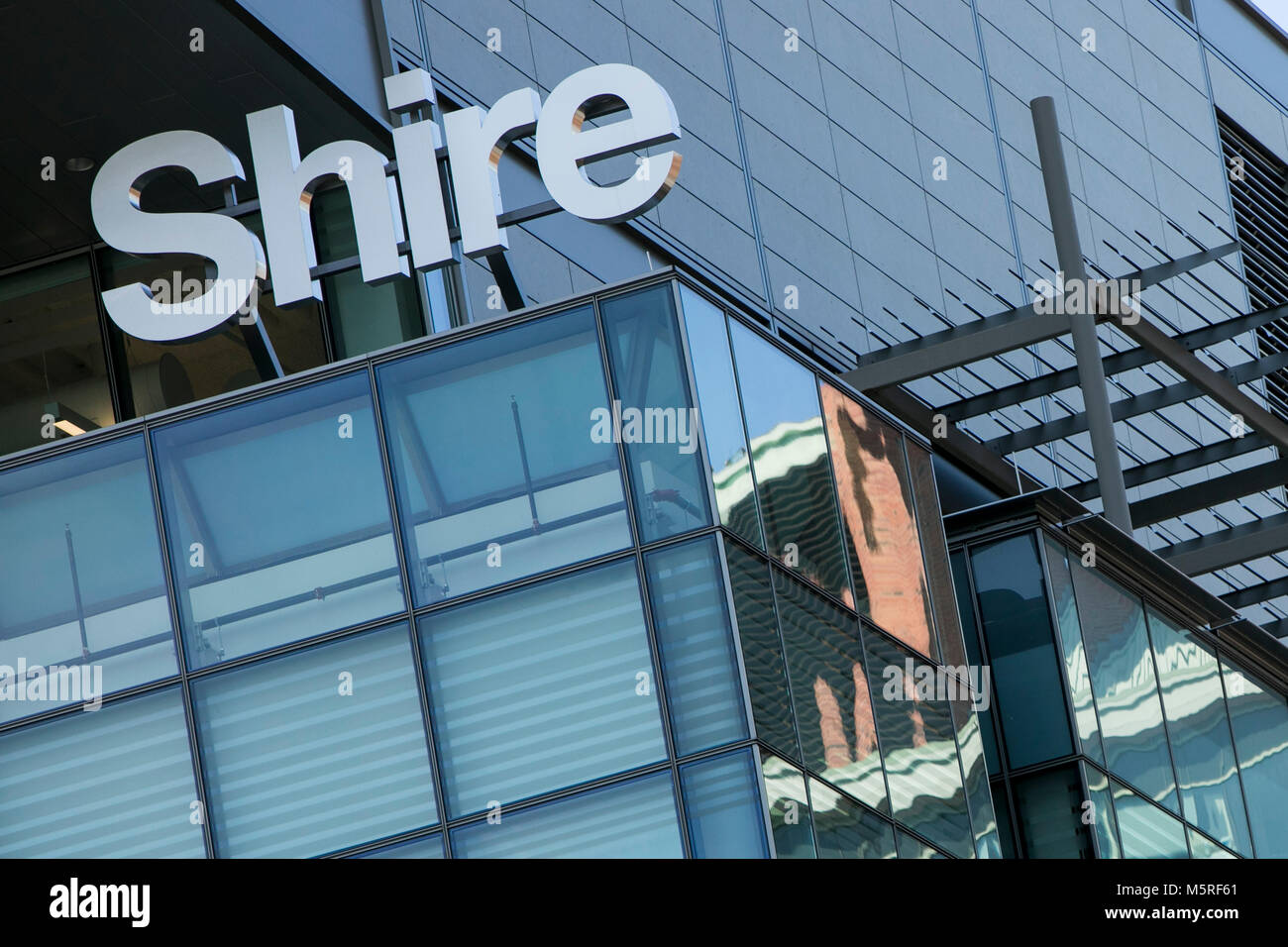 A logo sign outside of a facility occupied by Shire, Plc., in Cambridge ...