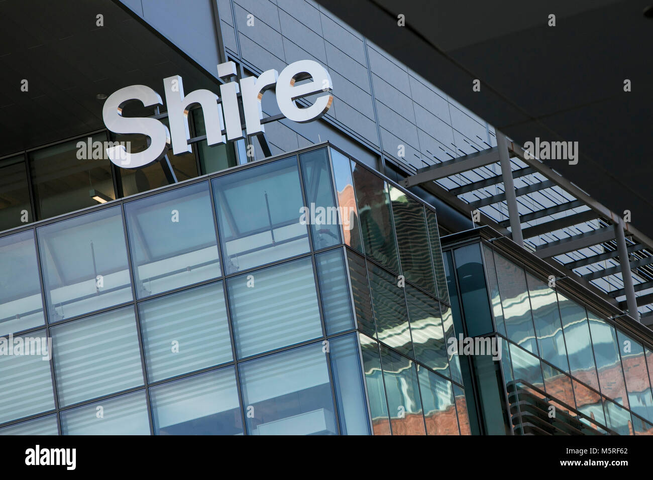 A logo sign outside of a facility occupied by Shire, Plc., in Cambridge ...