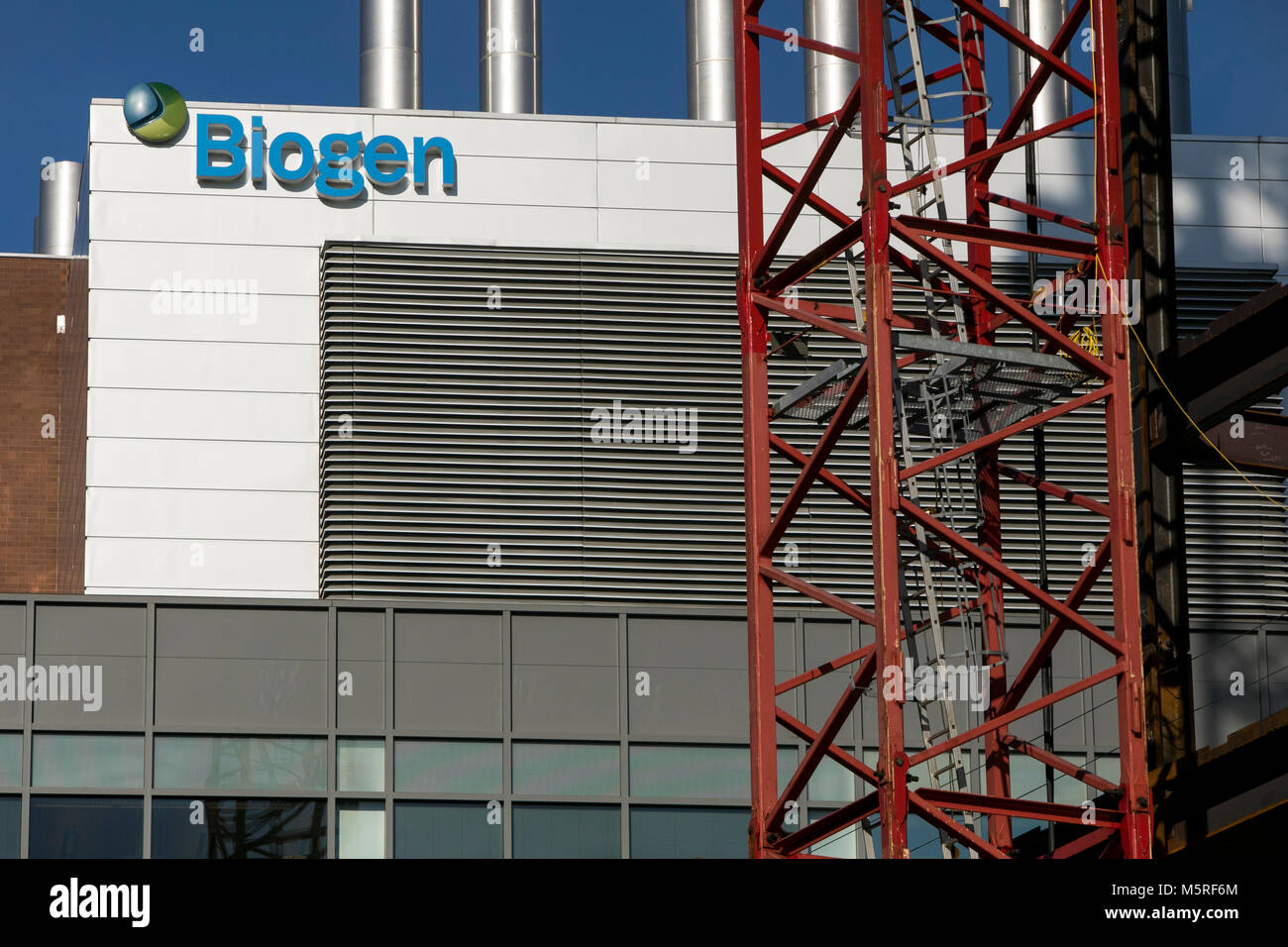 A logo sign outside of a facility occupied by Biogen, Inc., in ...