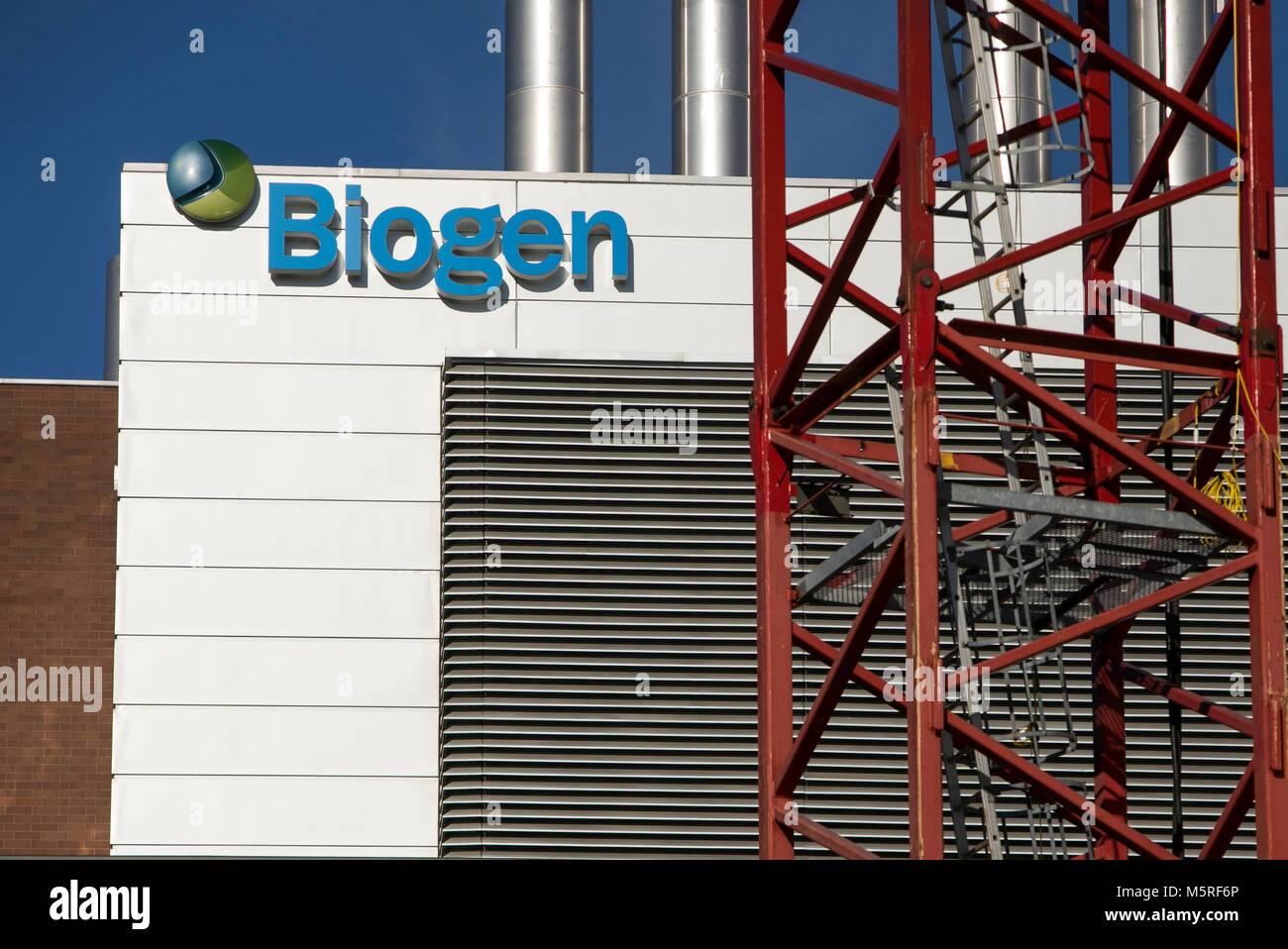 A logo sign outside of a facility occupied by Biogen, Inc., in ...
