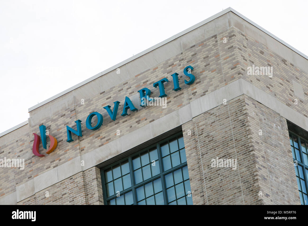 A logo sign outside of a facility occupied by Novartis International in ...