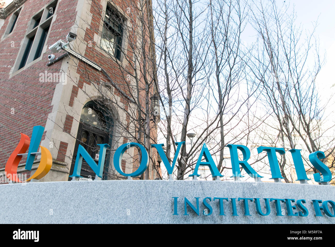 A logo sign outside of a facility occupied by Novartis International in ...