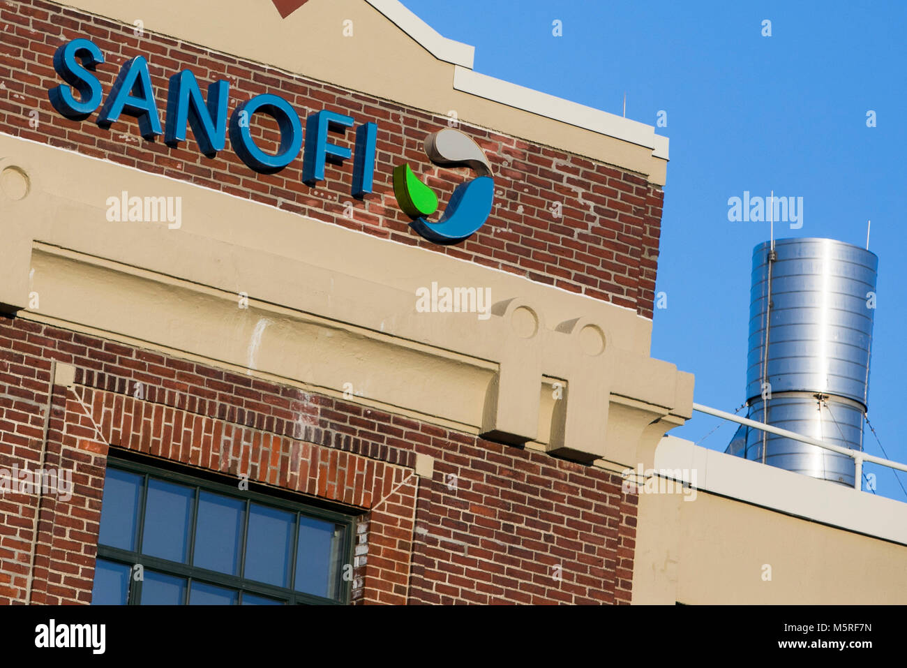 A logo sign outside of a facility occupied by Sanofi in Cambridge ...