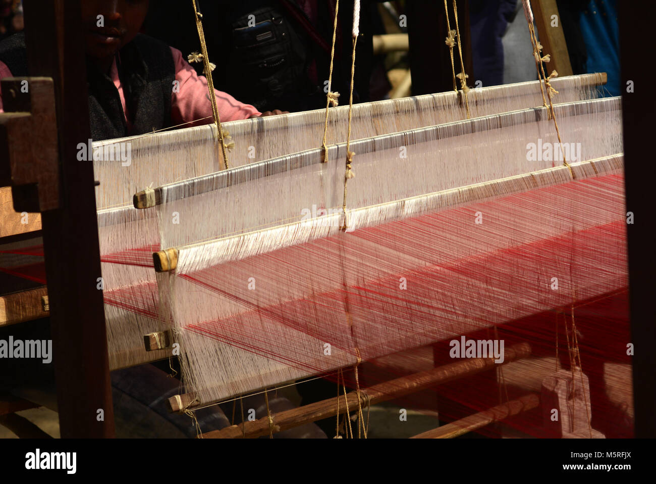 Cotton threads on loom weaving a cloth Stock Photo - Alamy
