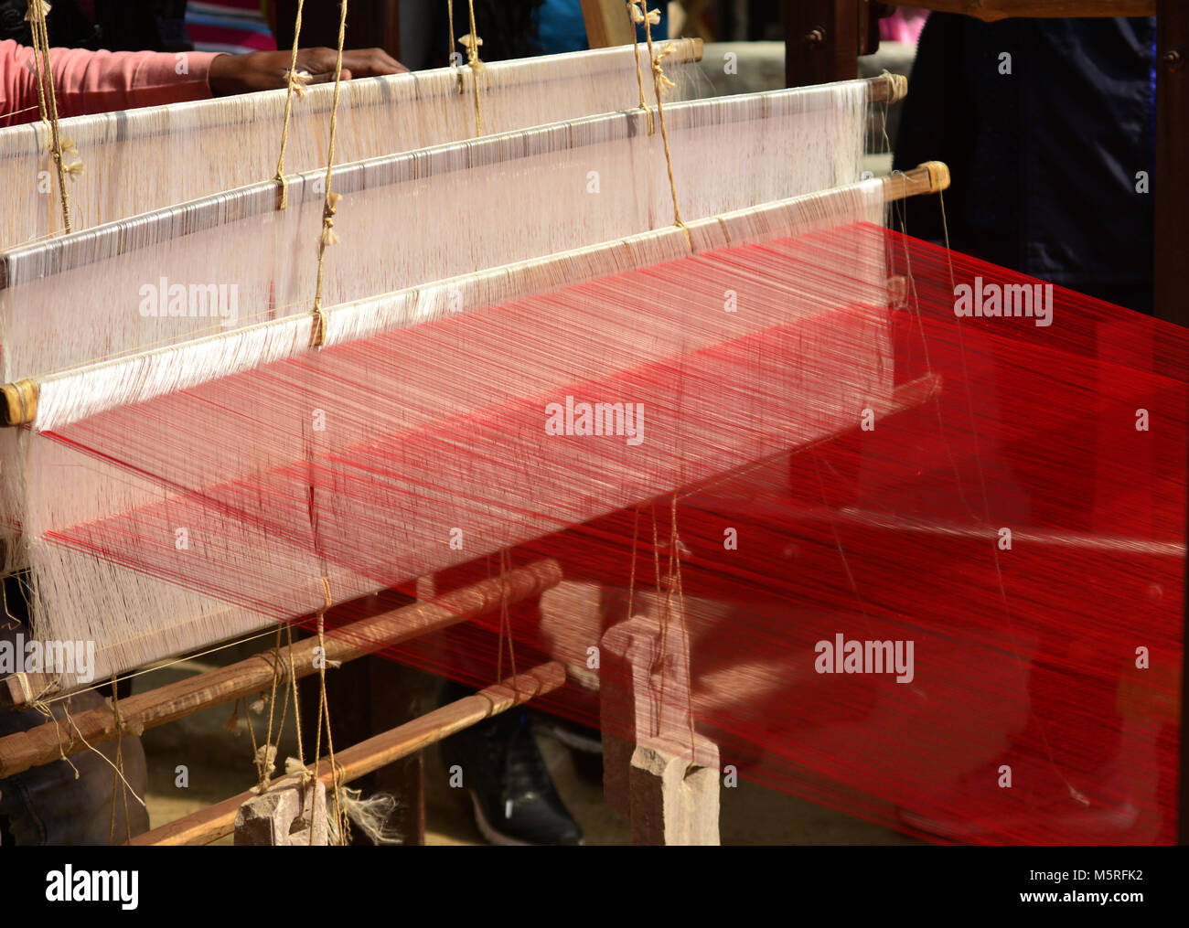 Cotton threads on loom weaving a cloth Stock Photo - Alamy