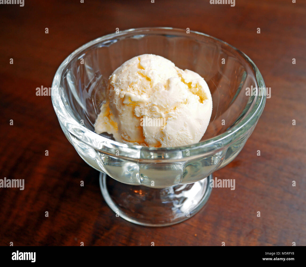 Scoop of vanilla ice cream in a glass bowl Stock Photo - Alamy