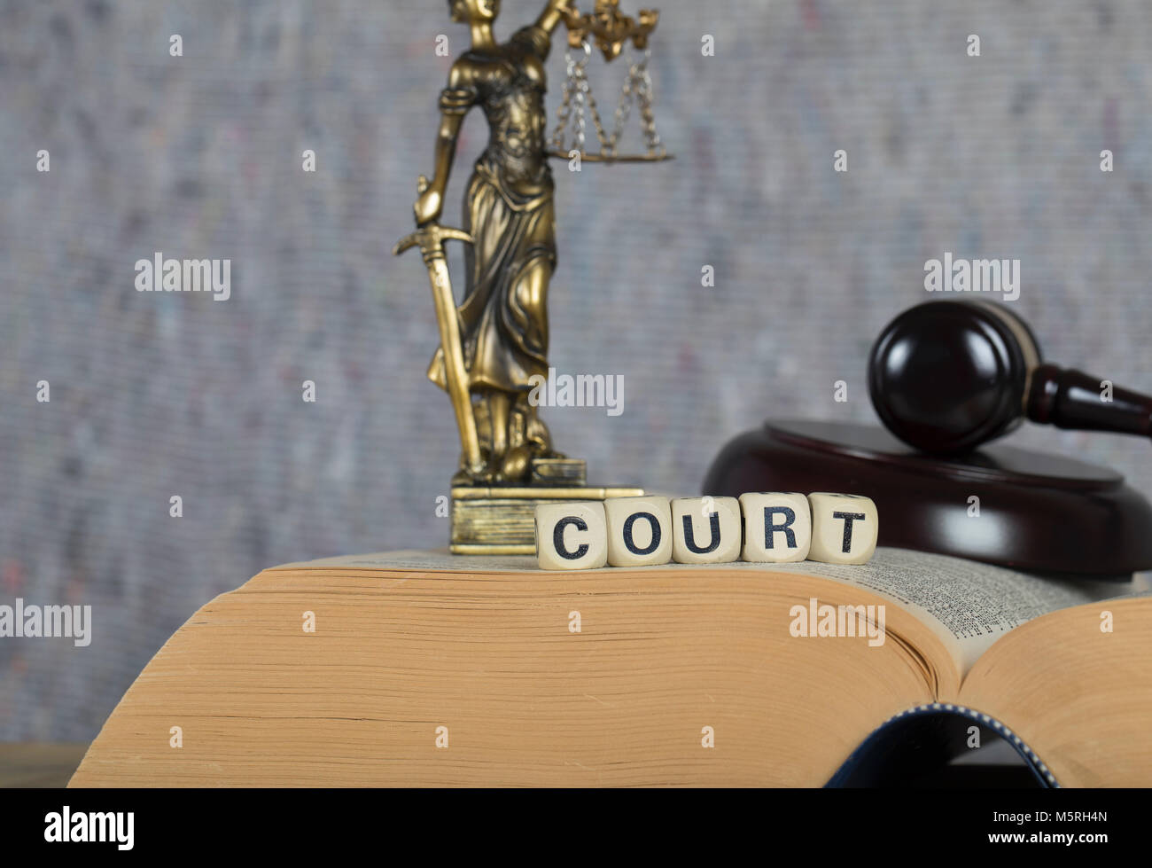 Word COURT composed of wooden letters. Statue Themis and judge's gavel ...