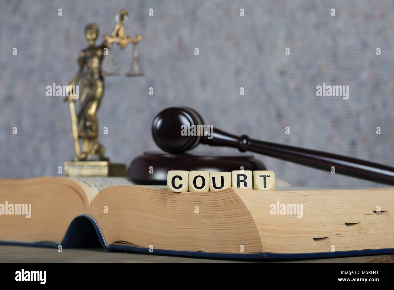 Word COURT composed of wooden letters. Statue Themis and judge's gavel ...