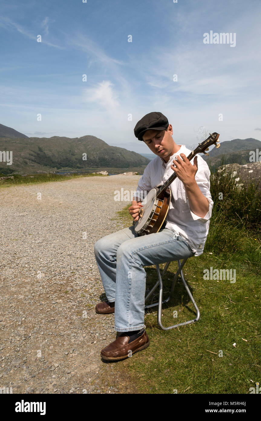 A young Irish busker playing his banjo near Lady's View, a few miles ...