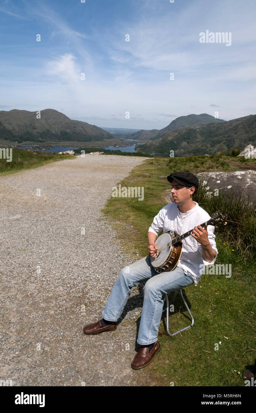 A young Irish busker playing his banjo near Lady's View, a few miles ...