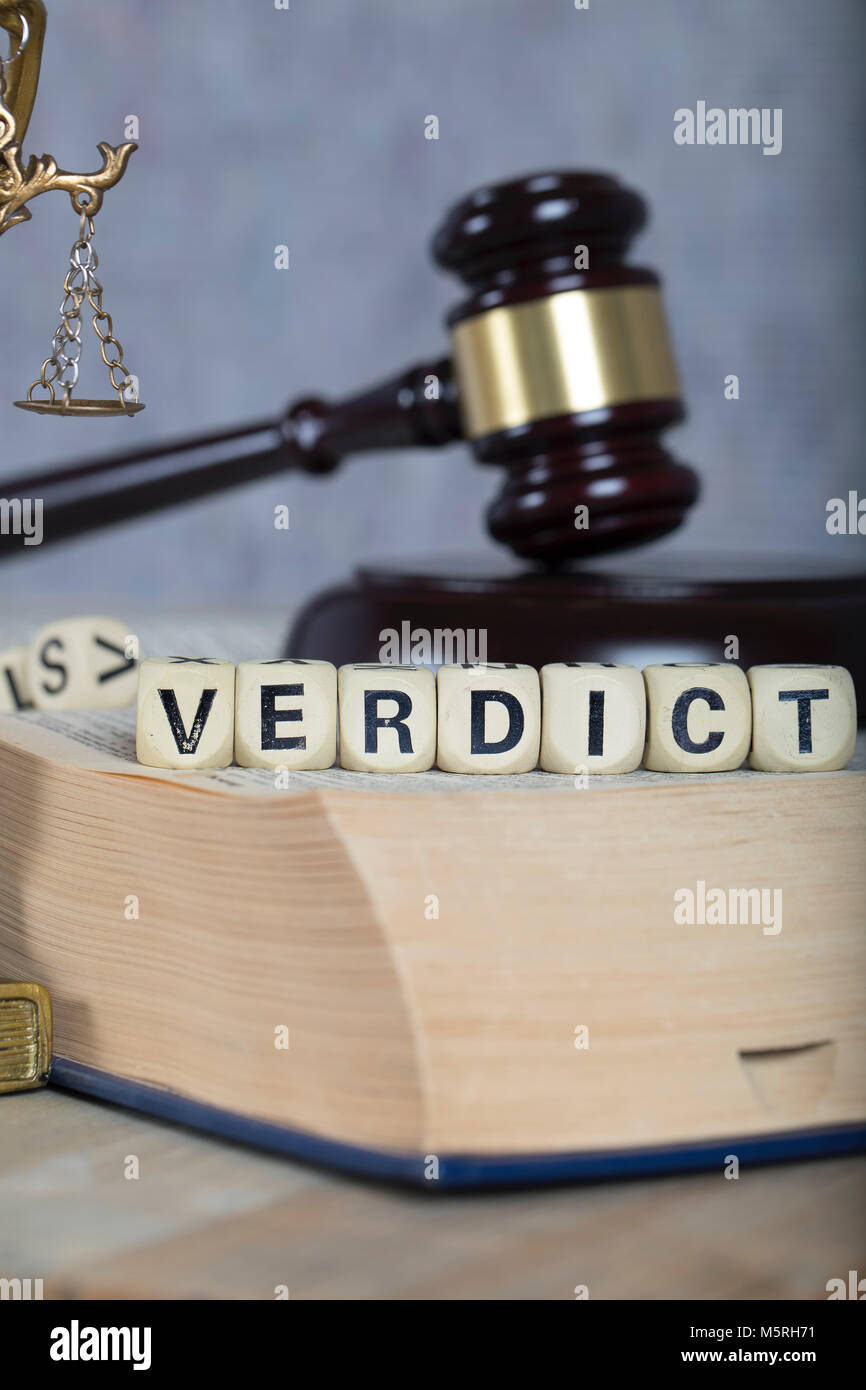 Word VERDICT composed of wooden letters. Statue of Themis and judge's ...