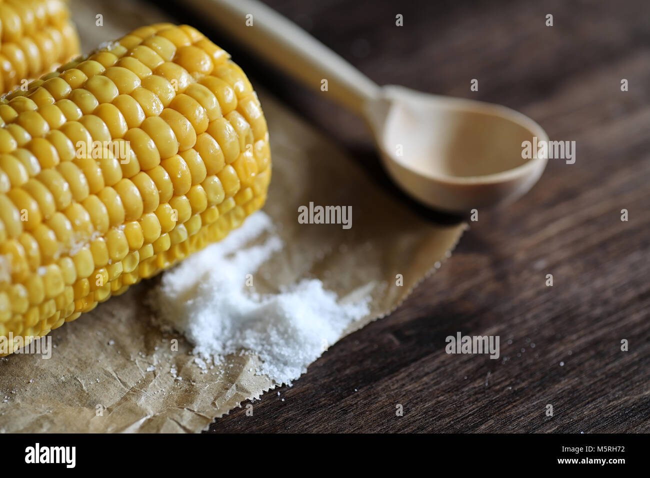 Boiled corn cob with salt on a wood Stock Photo - Alamy
