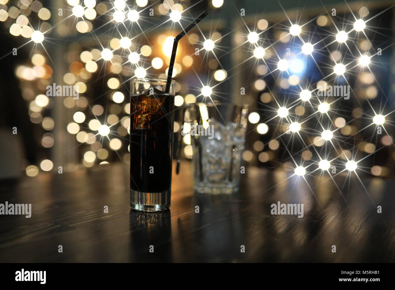 glass of cold alcohol drink with ice on table Stock Photo - Alamy