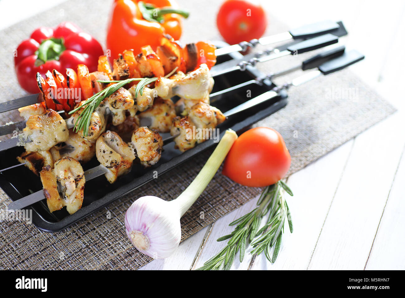 Kebab cooked on metal skewers with vegetables Stock Photo - Alamy