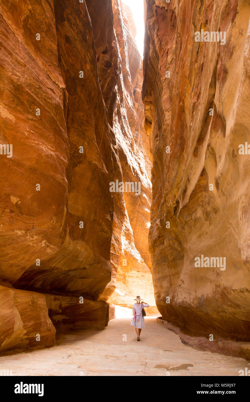 PETRA, JORDAN - APRIL 25, 2016: A narrow passage between steep rock ...