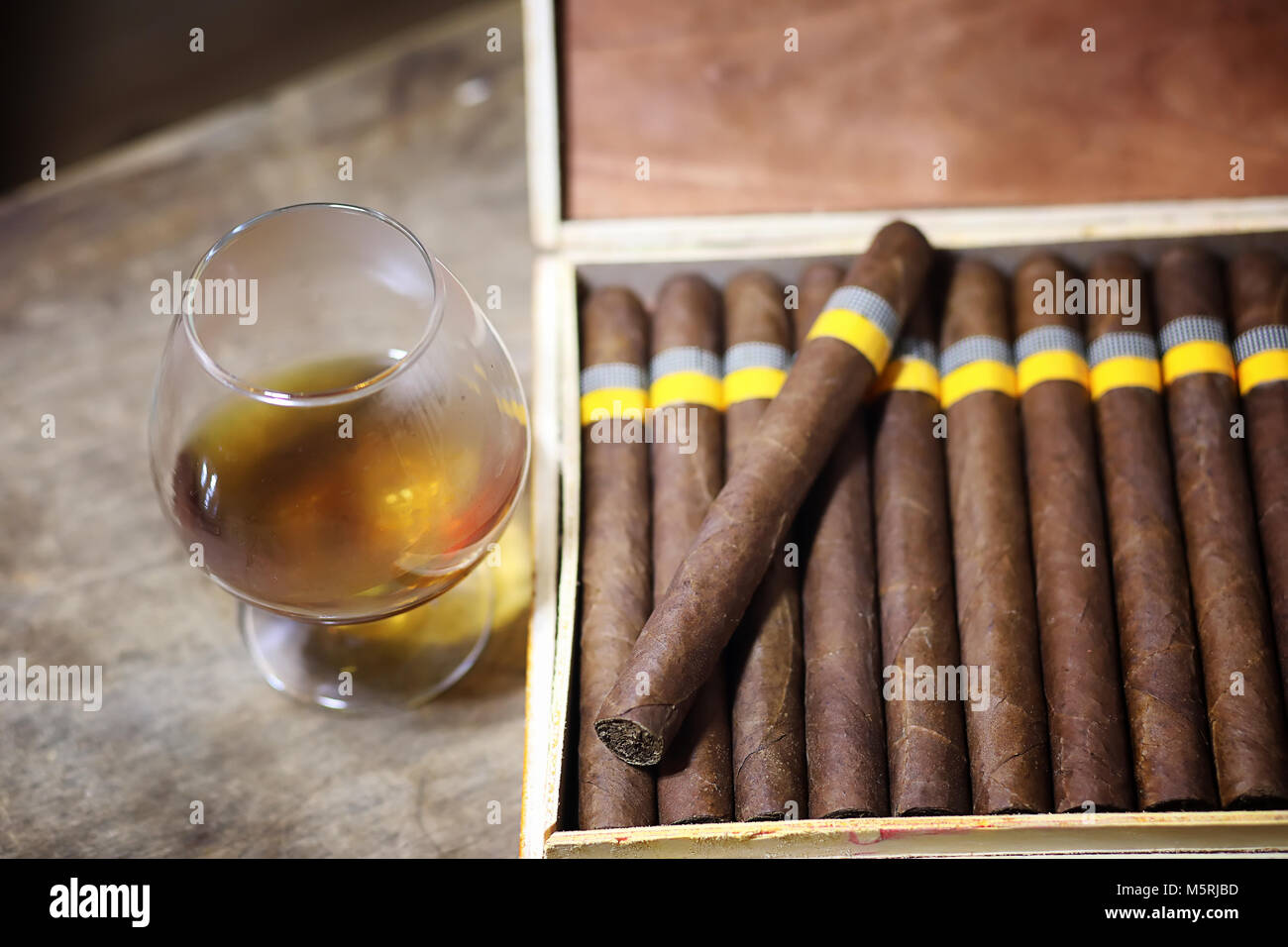 Large box of Cuban cigars on a wooden table Stock Photo - Alamy