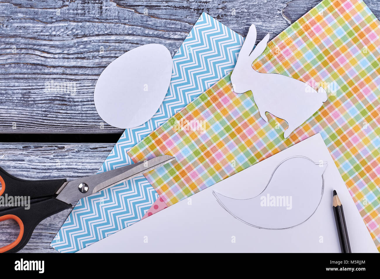 Papercut figures and colorful paper sheets Stock Photo - Alamy