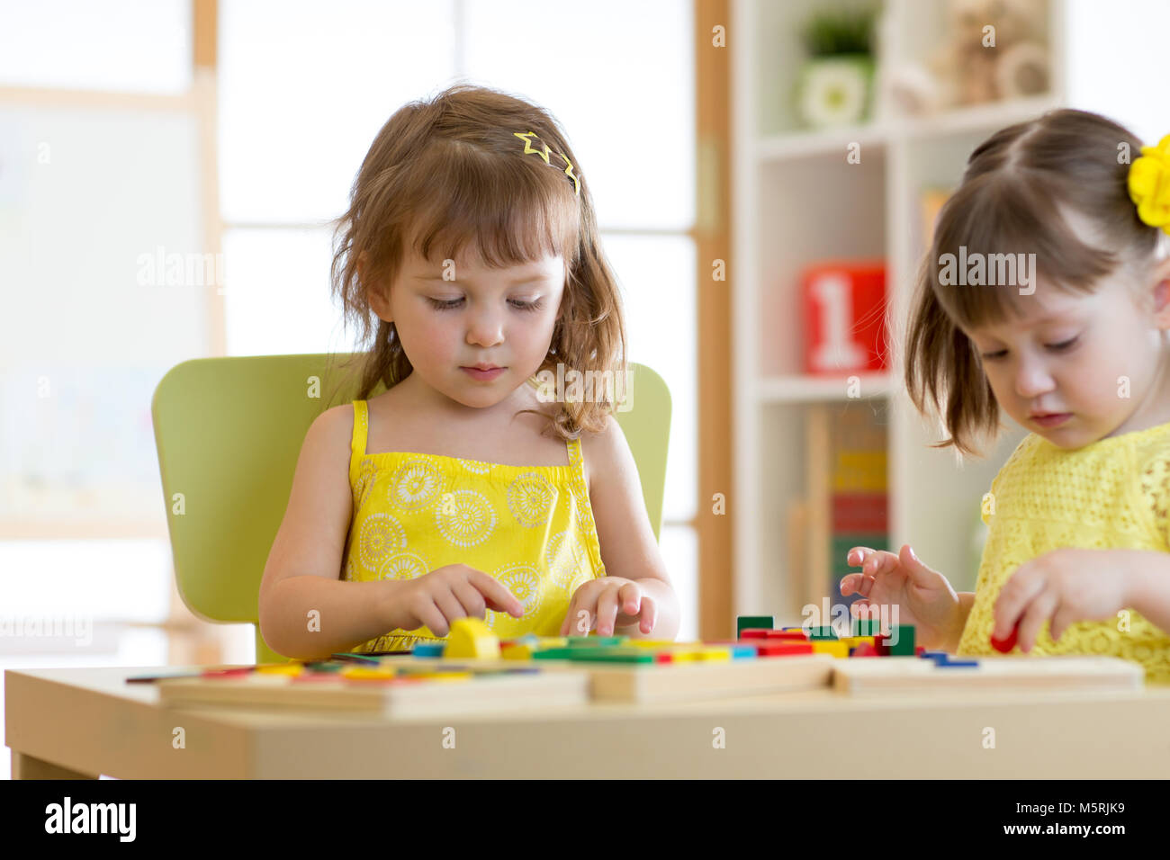 Children play educational toys in kindergarten Stock Photo - Alamy