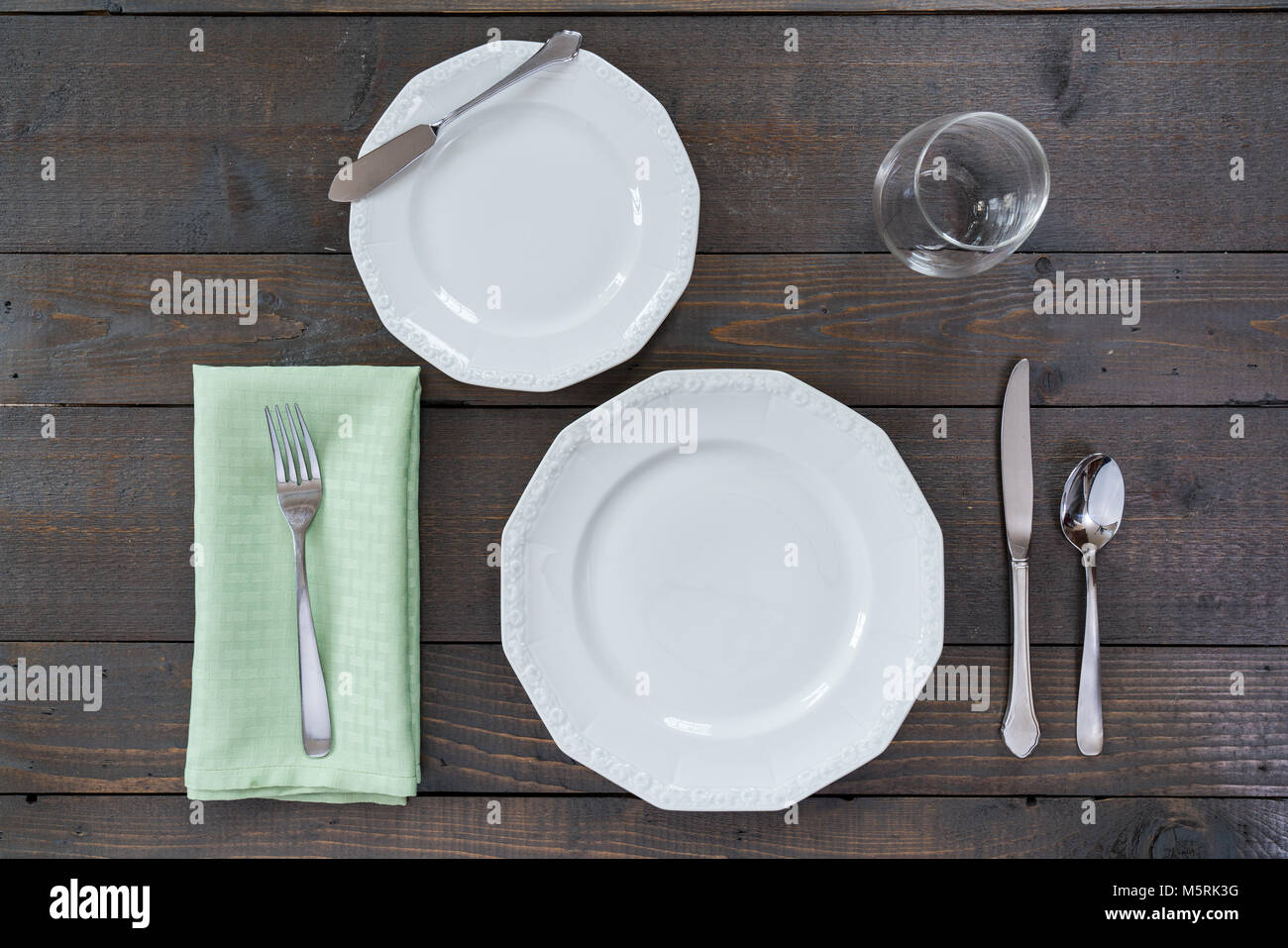 Dining place setting on a rustic wood background Stock Photo - Alamy