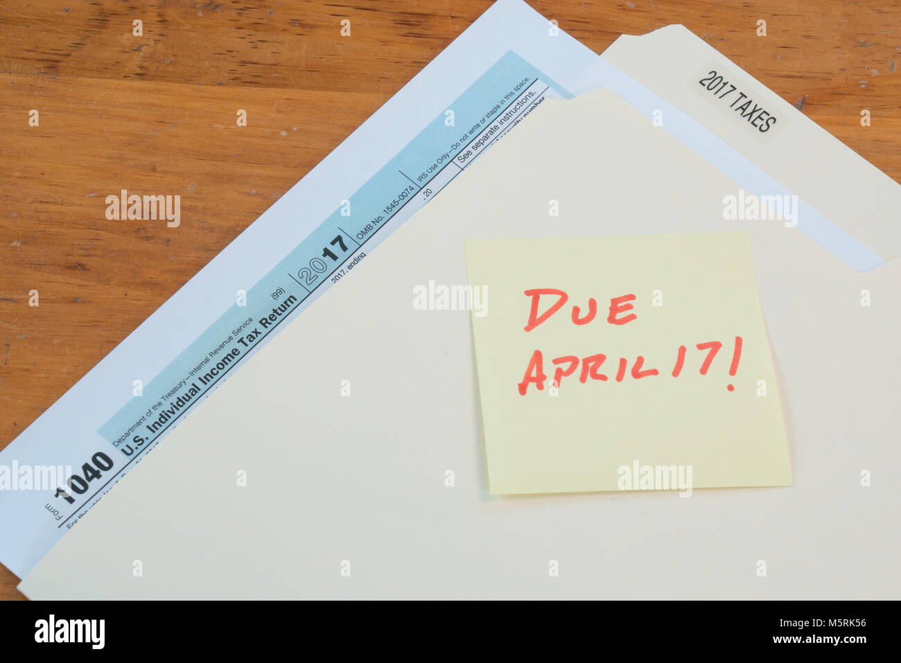 Tax folder with reminder for taxes due on April 17th Stock Photo - Alamy