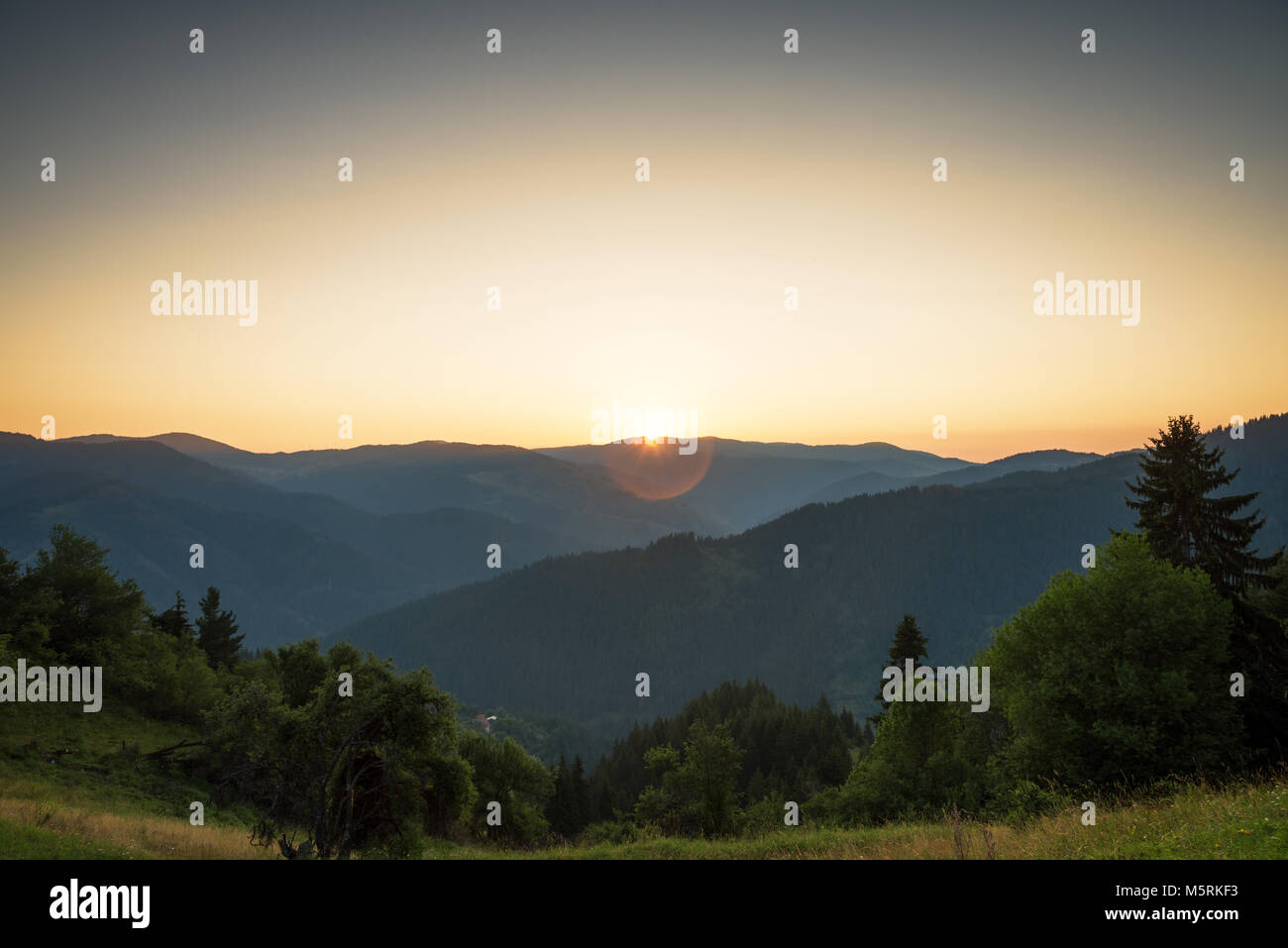 Panoramic view of colorful sunrise in mountains in summer Stock Photo ...