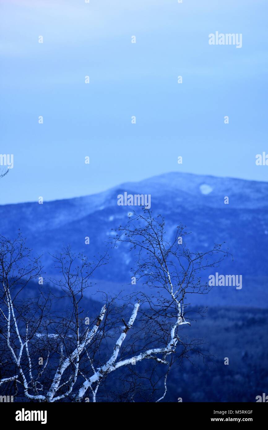 Monochromatic sunset over distant mountains in Lake Placid, NY, in the ...