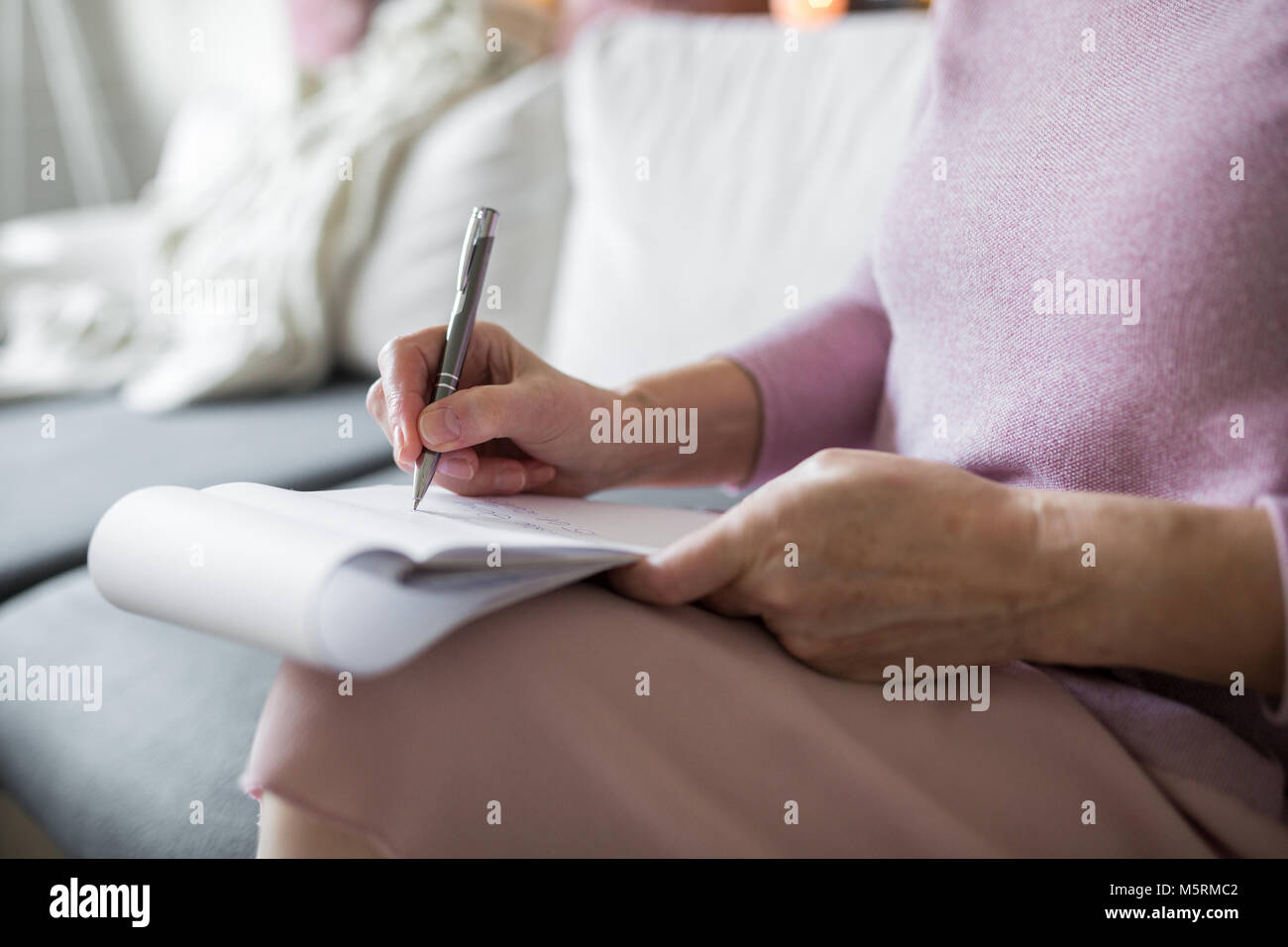 Cropped portrait of senior lady holding notepad taking notes Stock ... Cropped portrait of senior lady holding notepad taking notes Stock ...