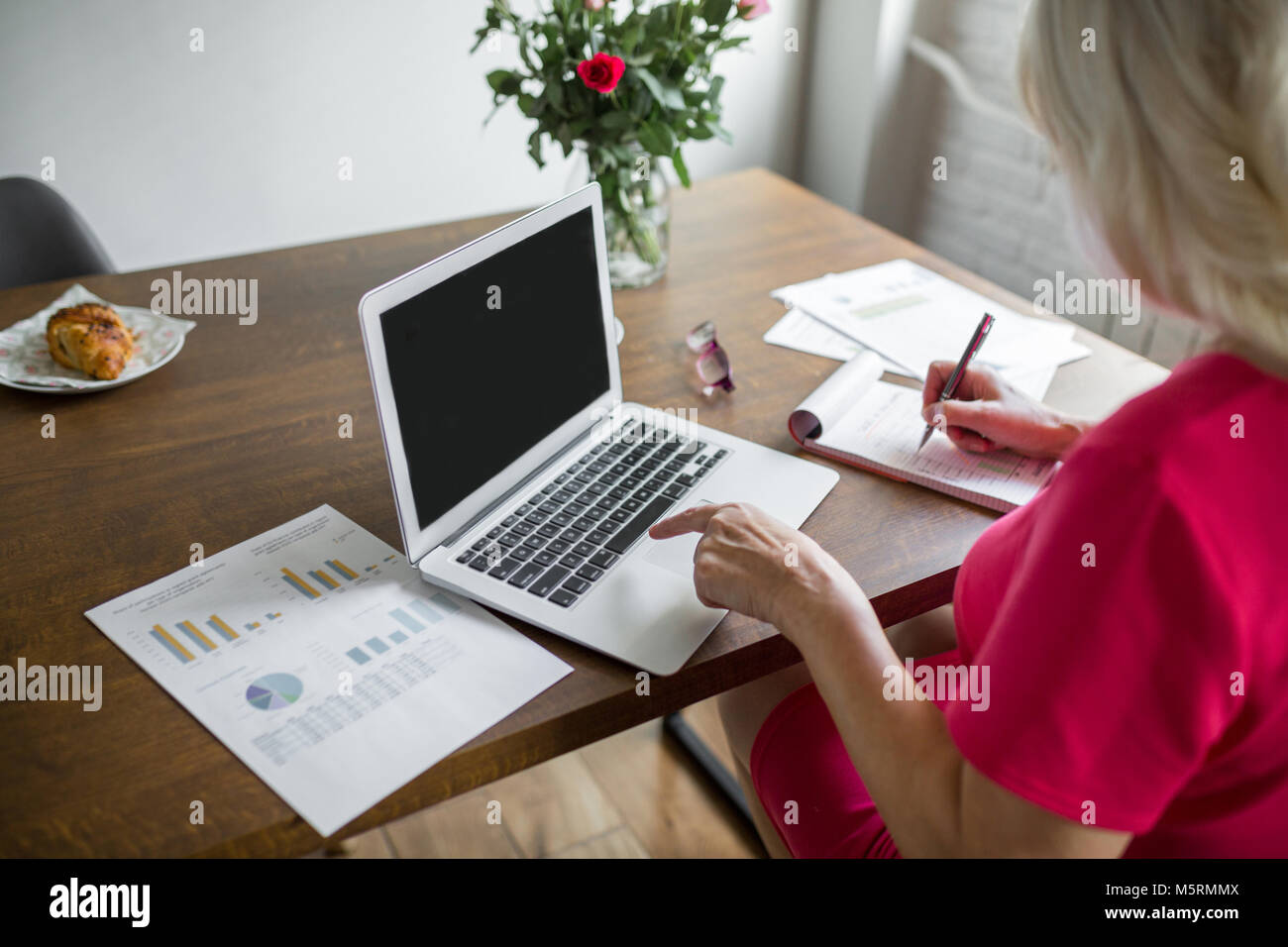 Mature adult writing kitchen table hi-res stock photography and images ...