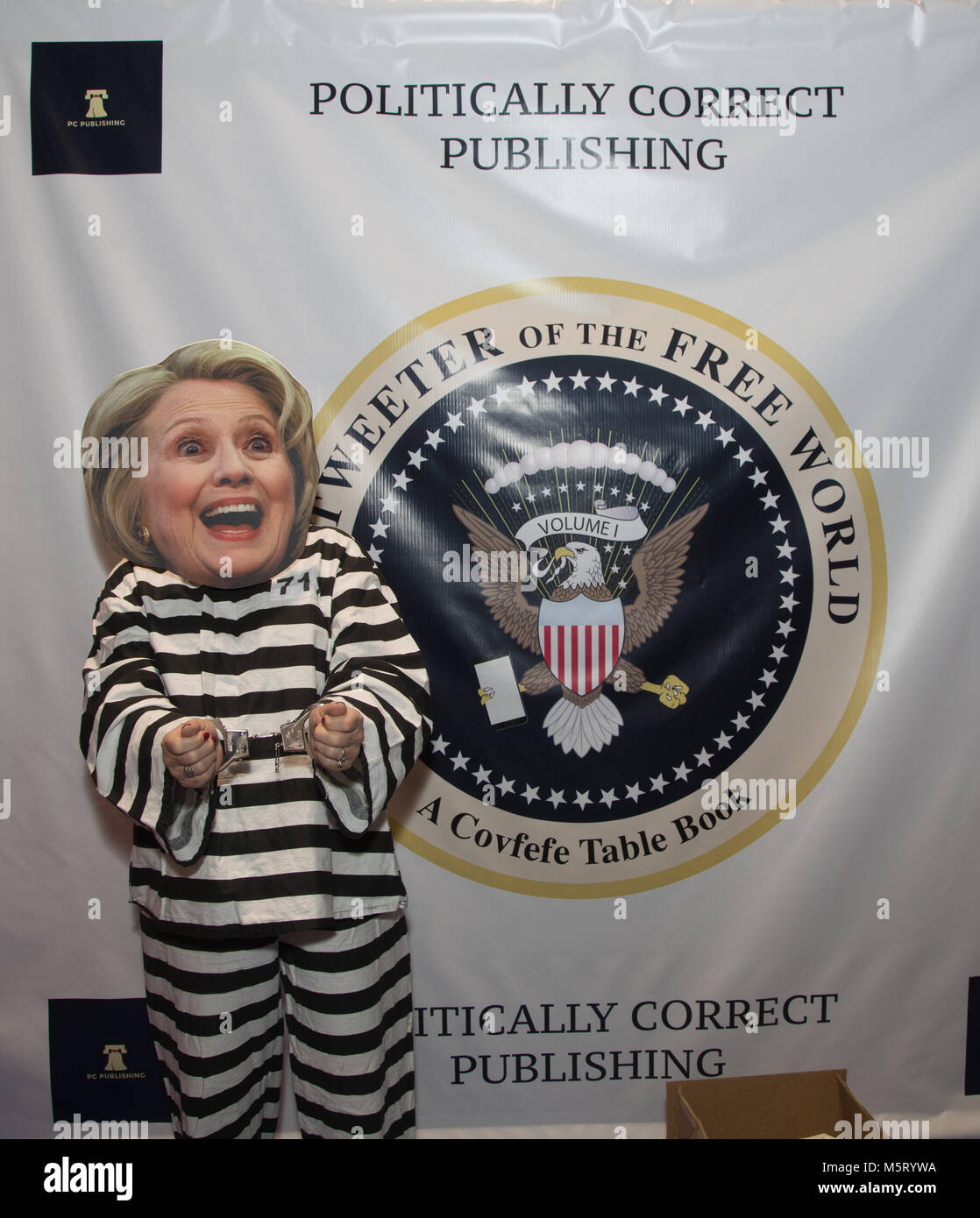 A women dressed as Hillary Clinton in a striped prison uniform wearing ...