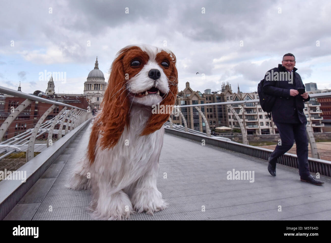 London, UK. 26 February 2018. A giant dog is seen on Millennium Bridge ...