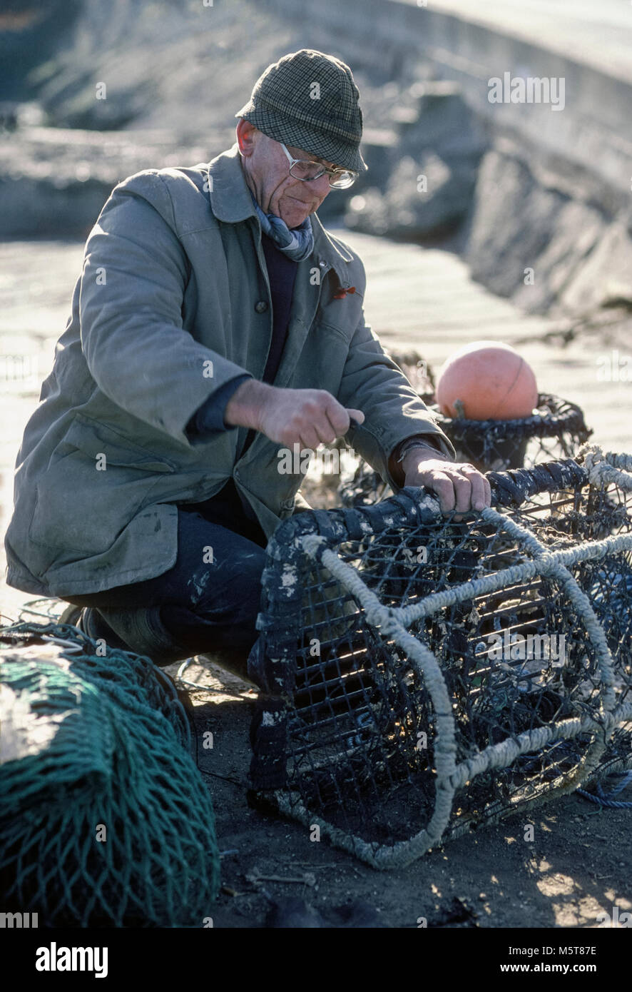 Fisherman repairing lobster pot Stock Photo - Alamy