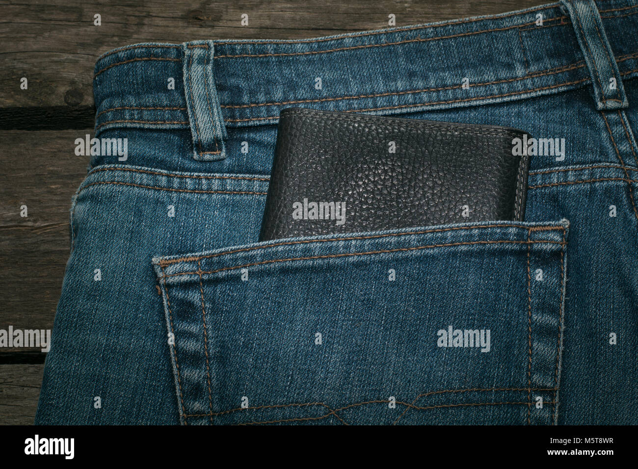 Black wallet and blue jeans back pocket. Close up Stock Photo - Alamy