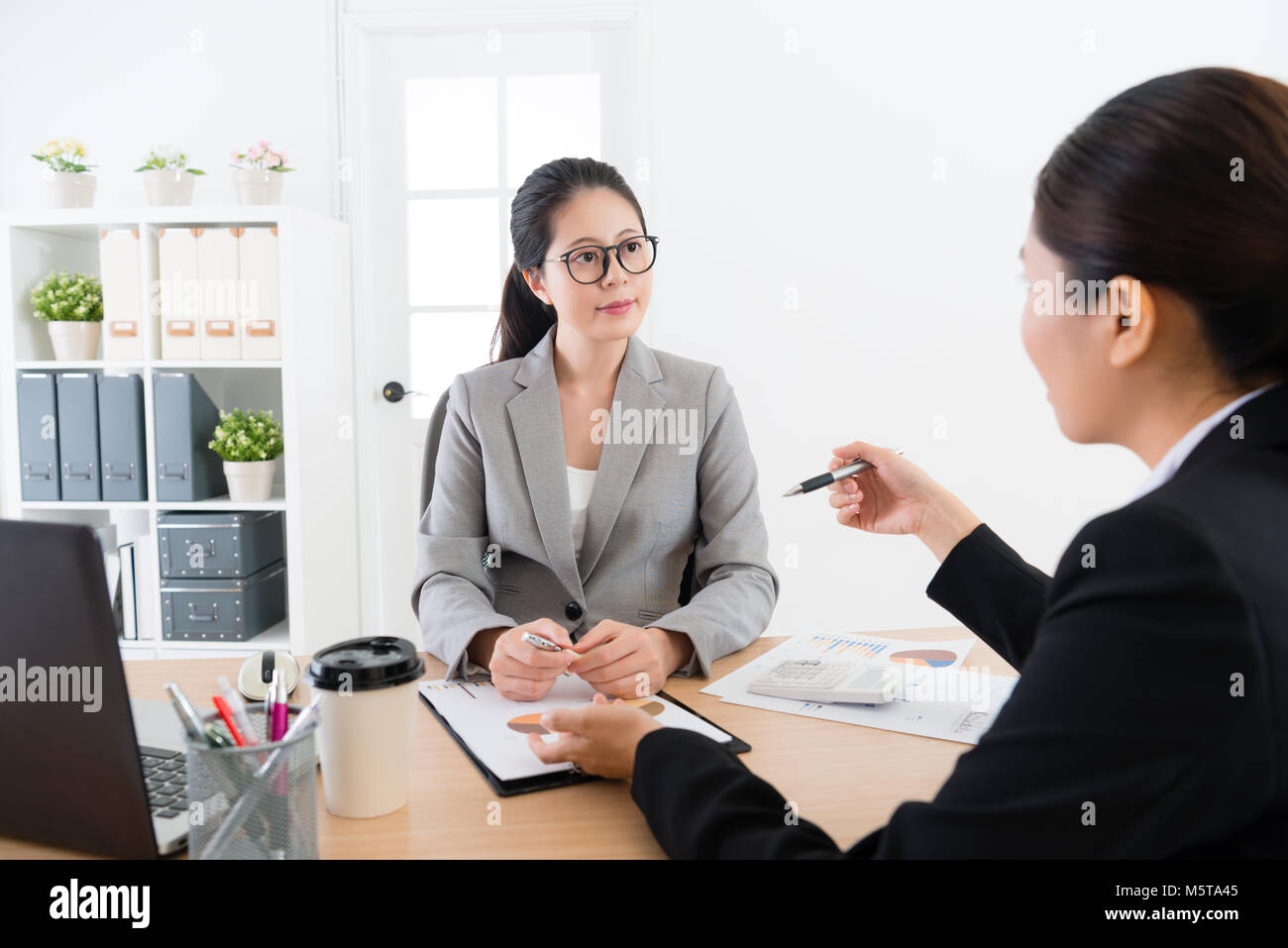 Female Asian bisiness lady communicating negotiating dealing talking ...
