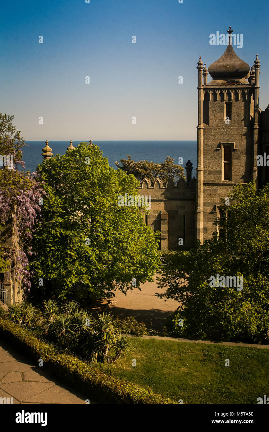 view of Vorontsov palace side facade tower against sea horizon and blue ...